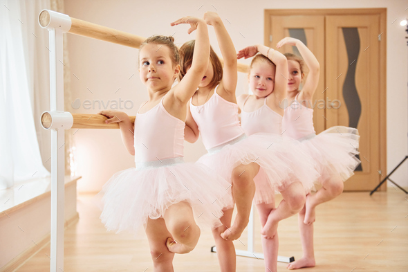 Little ballerinas preparing for performance by practicing dance moves ...