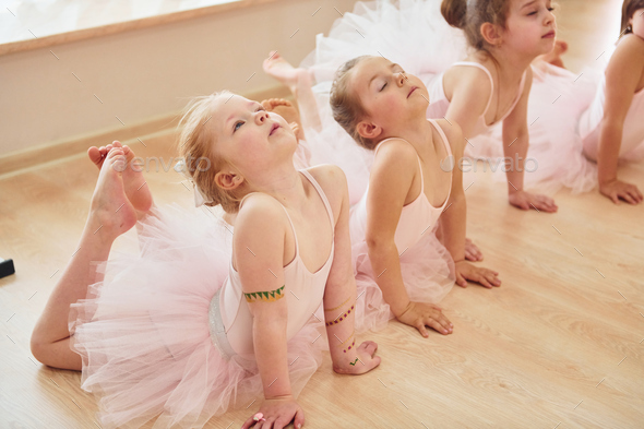Stretching exercises. Little ballerinas preparing for performance Stock ...
