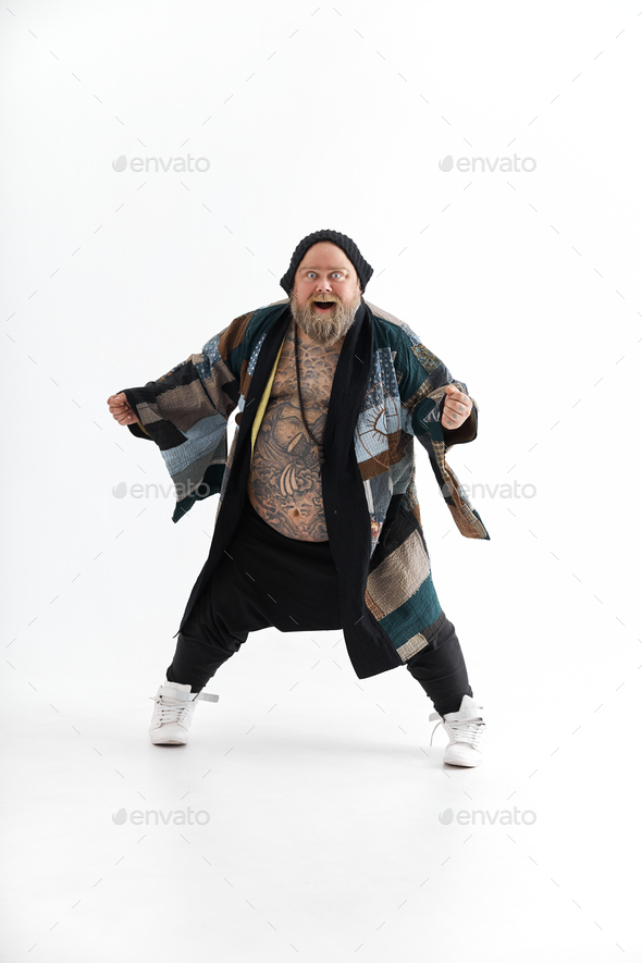 Fat stylish bearded tattoed caucasian man with big belly is posing and ...