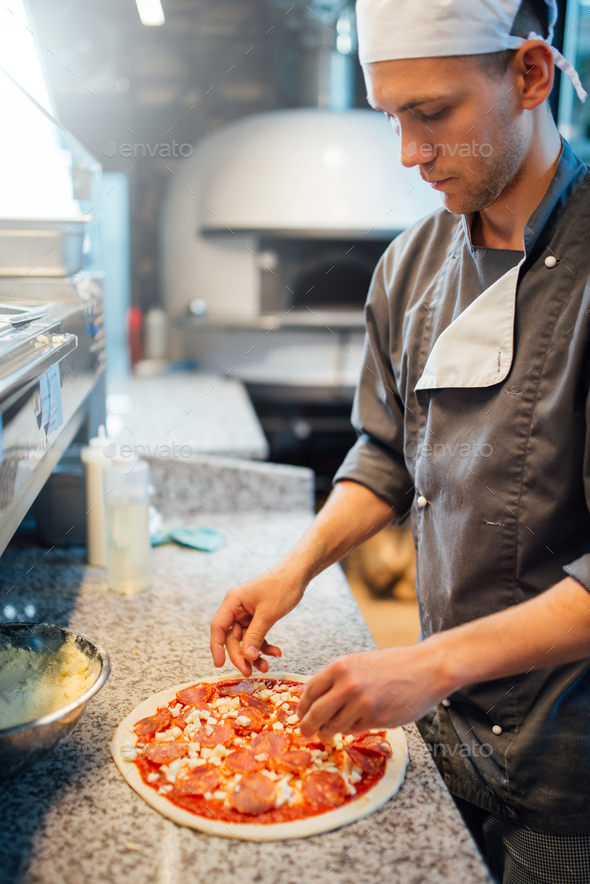 Chef makes pizza. Catering kitchen work. Stock Photo by Artranq | PhotoDune