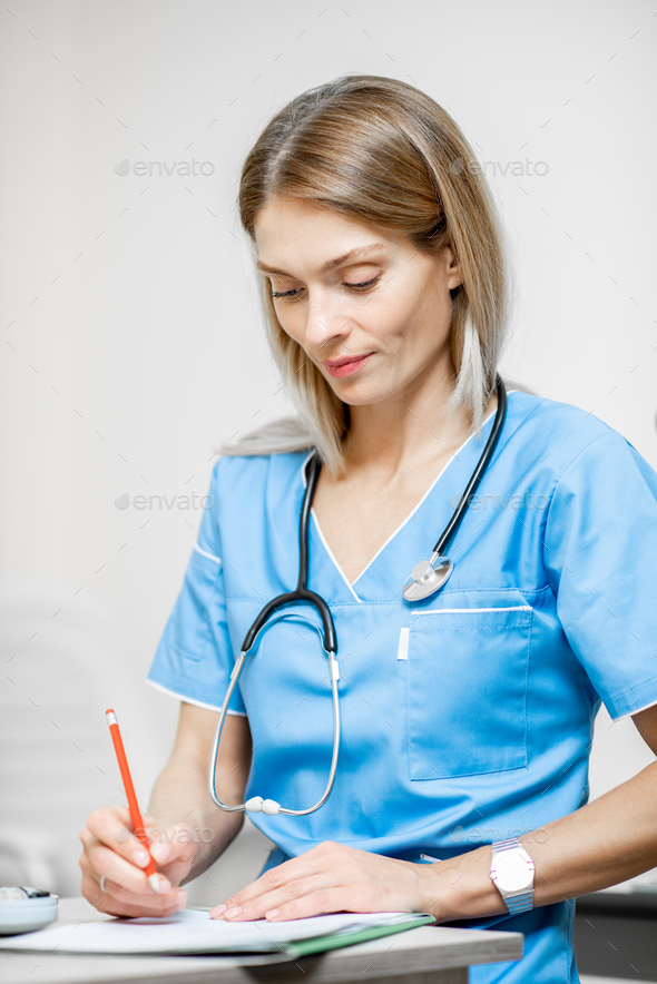 Nurse portrait during the paper work Stock Photo by RossHelen | PhotoDune