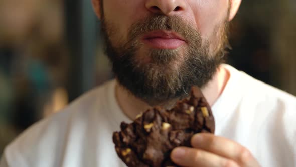 Man Eats a Chocolate Chip Cookies in a Cafe, Stock Footage | VideoHive