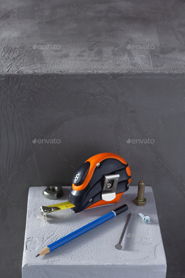 engineer tool on concrete cube or cement block and wall background ...