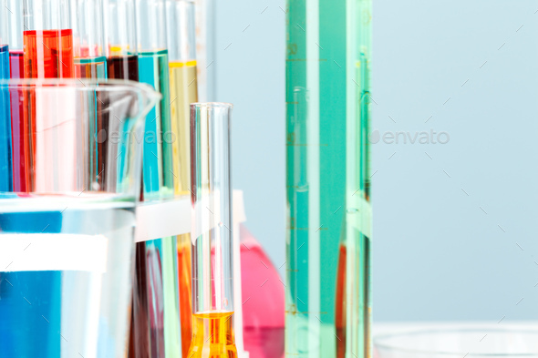 Colored liquids inside lab glassware on white table in laboratory Stock ...