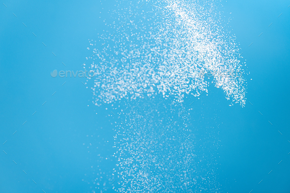 White powder explosion. White powder splash isolated on blue background ...
