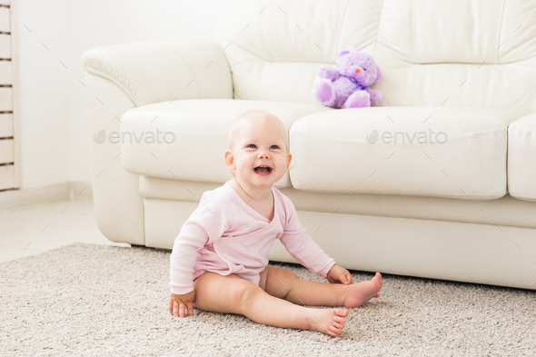 childhood, babyhood and people concept - happy little baby girl sitting ...