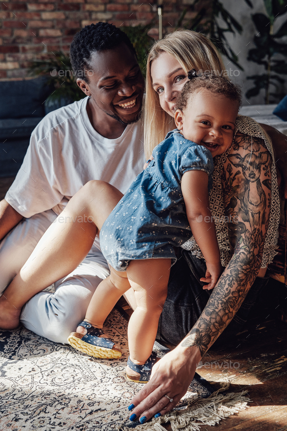 Mixed race family posing together on camera inside room Stock Photo by ...