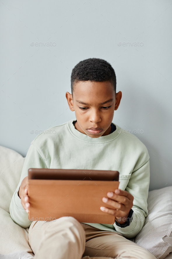 Teenager using Tablet Stock Photo by seventyfourimages | PhotoDune
