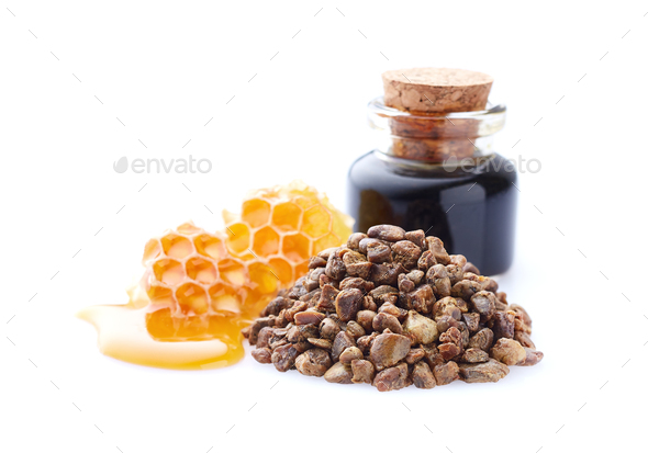 Propolis granules with honeycomb and tincture Stock Photo by Dionisvero