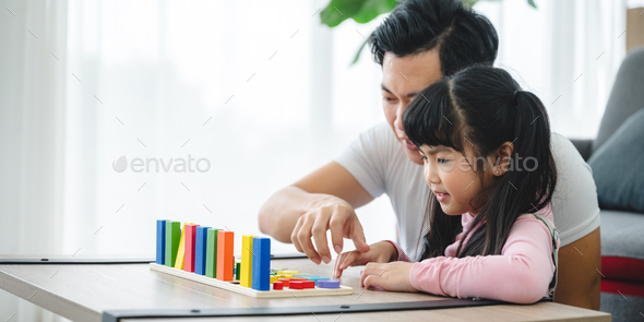 Cheerful and playful cute little girl learning numbers and math with ...