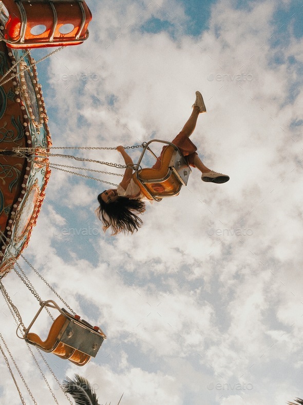 Woman riding a carousel Stock Photo by scopioimages | PhotoDune