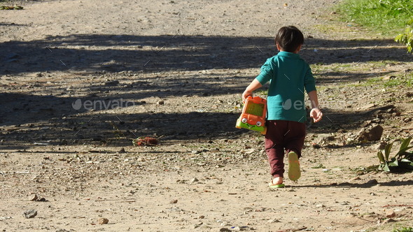 Back view of a boy walking outdoor Stock Photo by scopioimages | PhotoDune