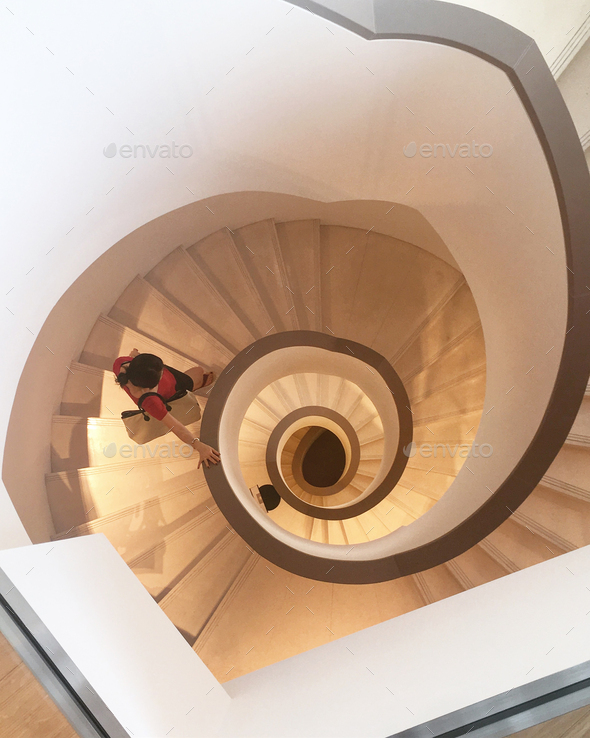 Top view of person walking down the spiral stairs Stock Photo by ...