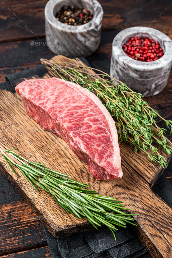 Wagyu A5 raw rump or sirloin steak, kobe beef meat on a butchery board ...