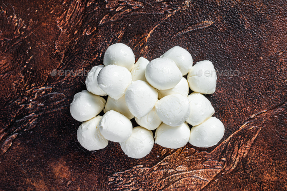 Buffalo mozzarella cheese mini balls on kitchen table. Dark background ...