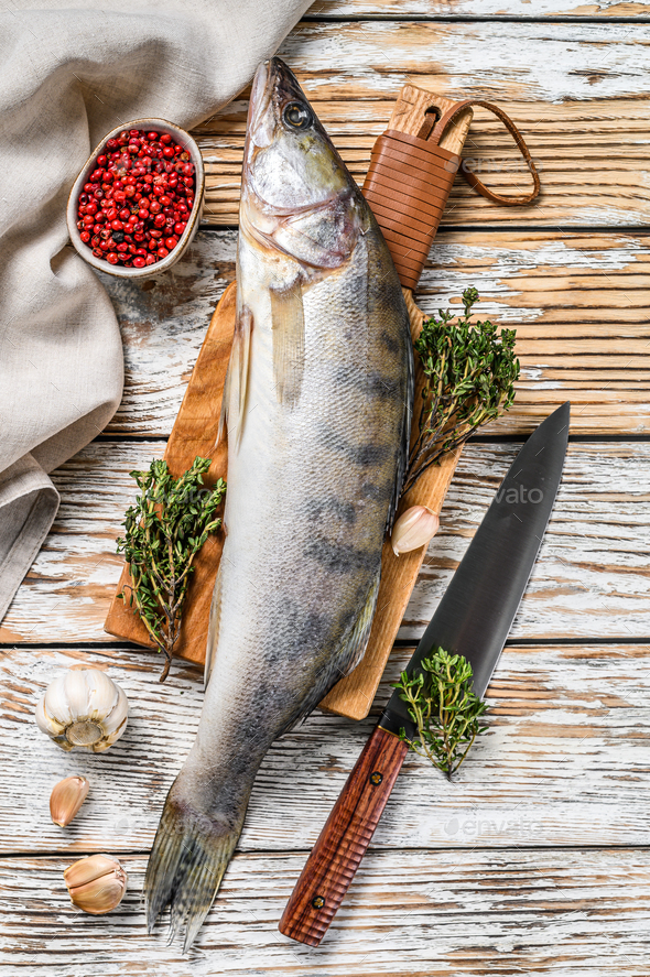 Raw pike perch, pikeperch fish on a cutting board. Fresh fish. White ...