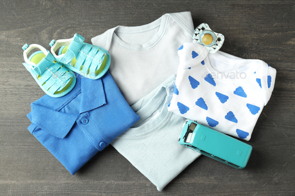 Concept of baby clothes on dark textured background Stock Photo by ...