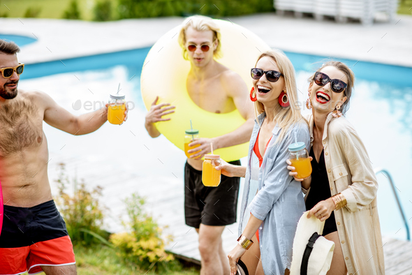 Group of happy friends on the swimming pool Stock Photo by RossHelen