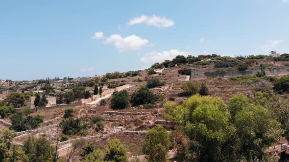 Rising aerial view of Malta island rural fields on sunny summer day ...