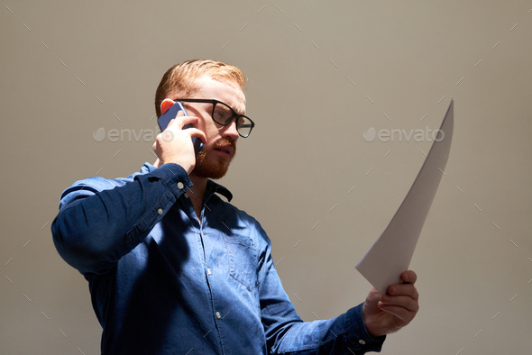 Frowning Businessman Analyzing Papers Isolated On Green Background ...