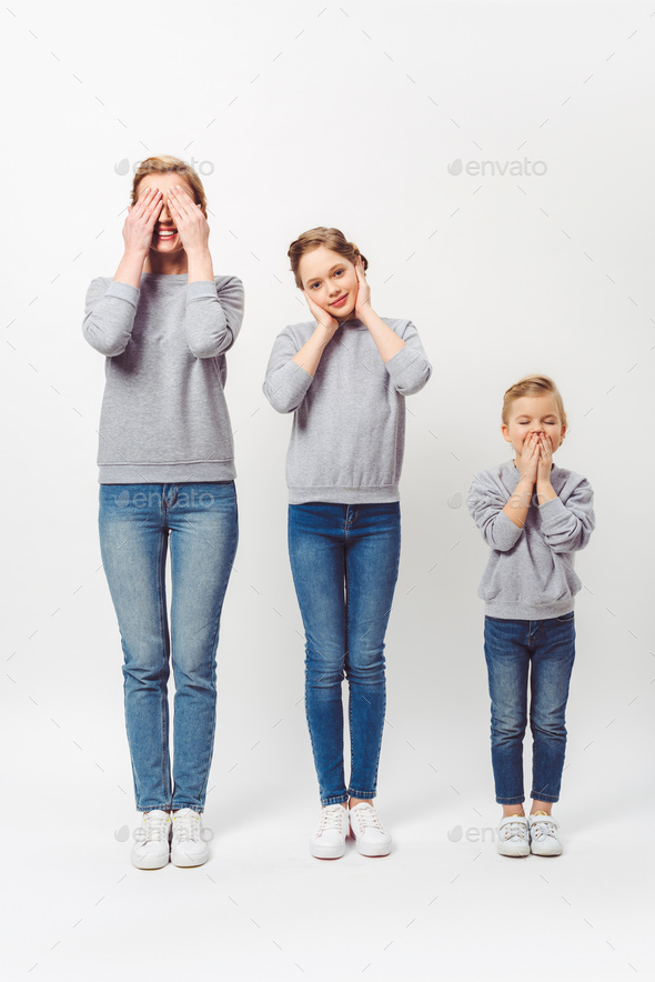 mother and daughters of different generations in similar clothing ...