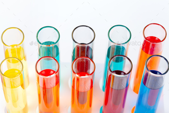 Colored liquids inside lab glassware on white table in laboratory Stock ...