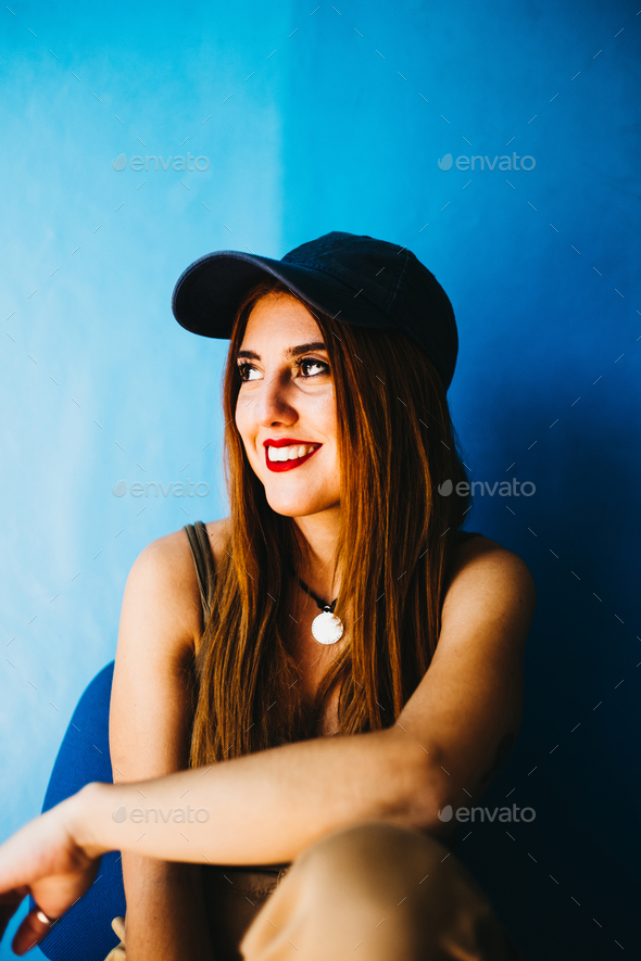 Smiling attractive lady in cap Stock Photo by ADDICTIVE_STOCK | PhotoDune