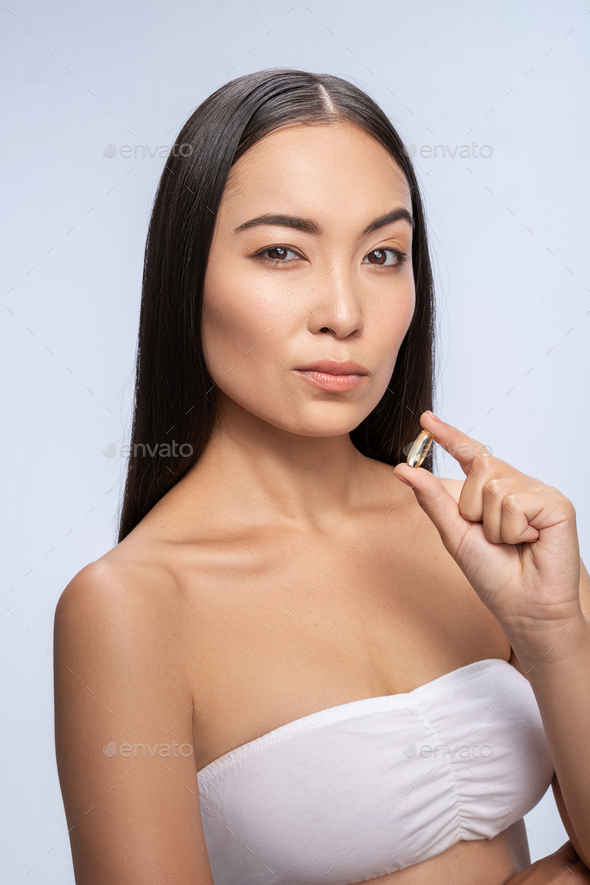 Portrait of beautiful lady with capsule with vitamin complex Stock ...
