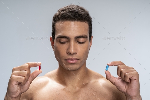 Good-looking man beginning his day with taking meds Stock Photo by ...