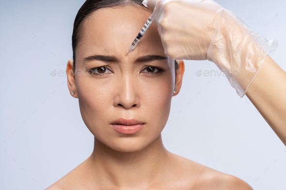 Portrait of emotional girl that doing injection Stock Photo by Iakobchuk