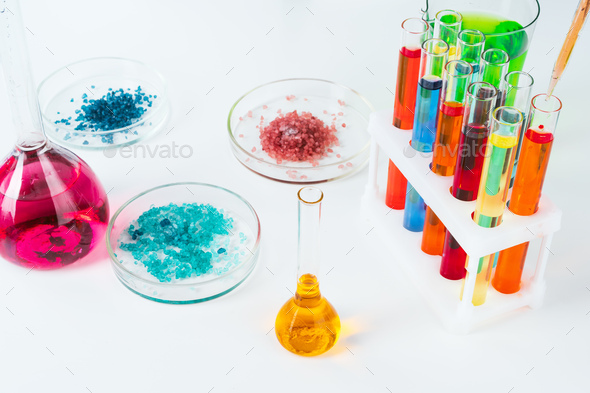 Colored liquids inside lab glassware on white table in laboratory Stock ...