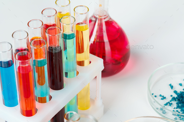 Colored liquids inside lab glassware on white table in laboratory Stock ...