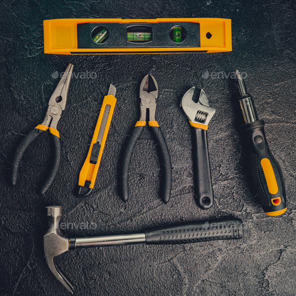 Basic Home Repair Tools On Black Background Stock Photo by EwaStudio