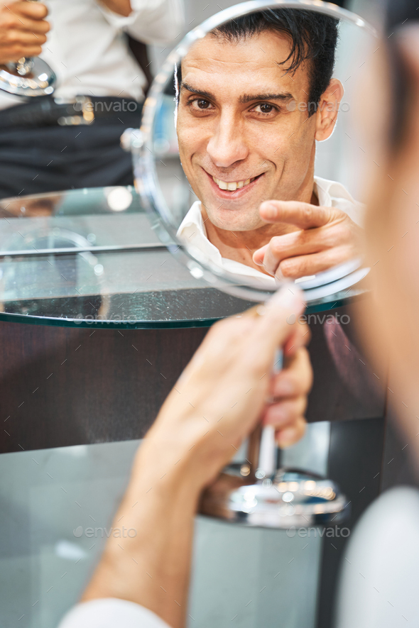 Man pointing at himself in mirror with cheeky expression Stock Photo by ...
