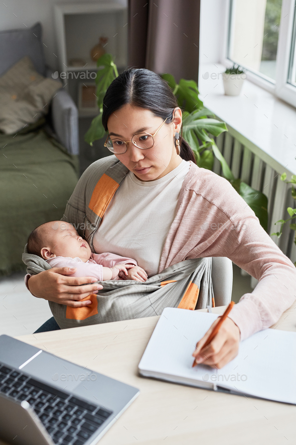 Woman studying at home during her maternity leave Stock Photo by ...