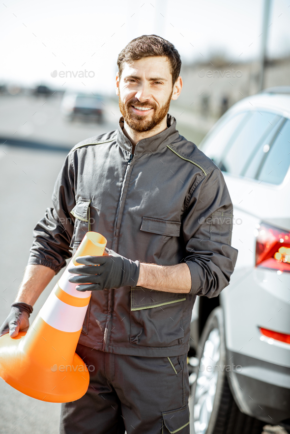 Road assistance worker on the roadside Stock Photo by RossHelen | PhotoDune