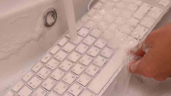 Woman Washing White Computer Keyboard with a Sponge with Foam, Stock ...
