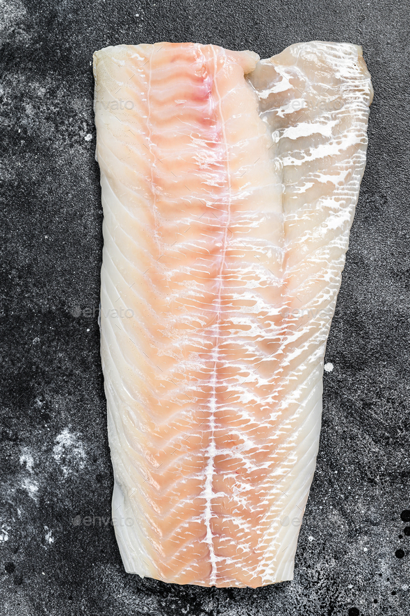Raw Norwegian skrei cod fish fillet. Black background. Top view Stock ...