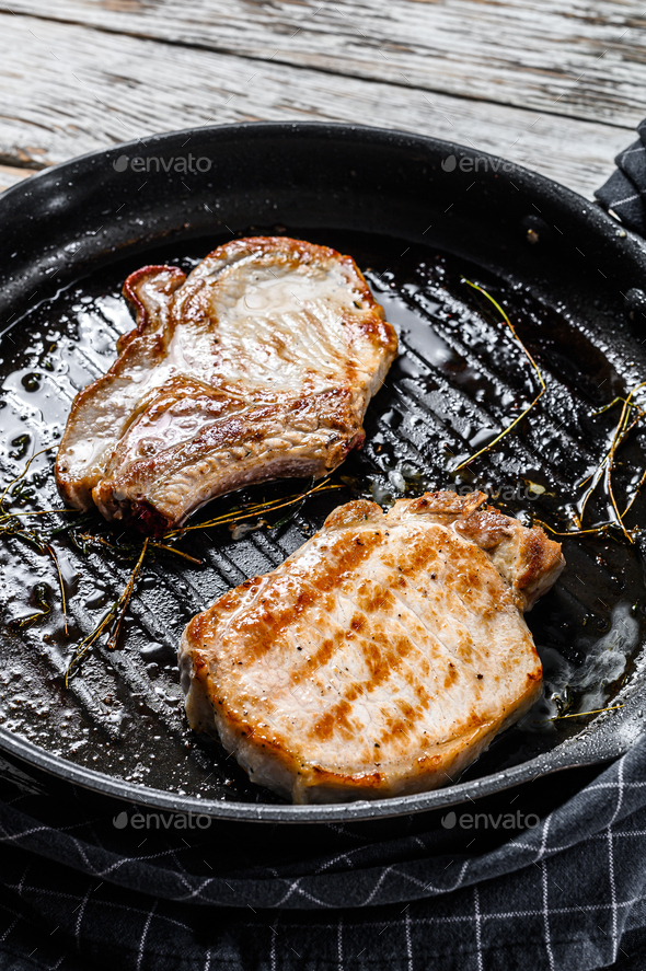 Grilled pork cutlets in a pan. Organic meat steak. White background ...