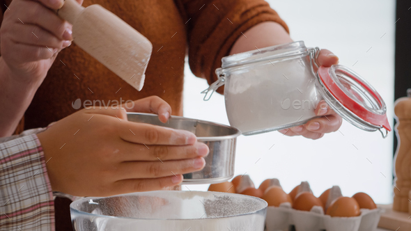 Closeup of grandmother putting flour ingredient in strainer Stock Photo ...