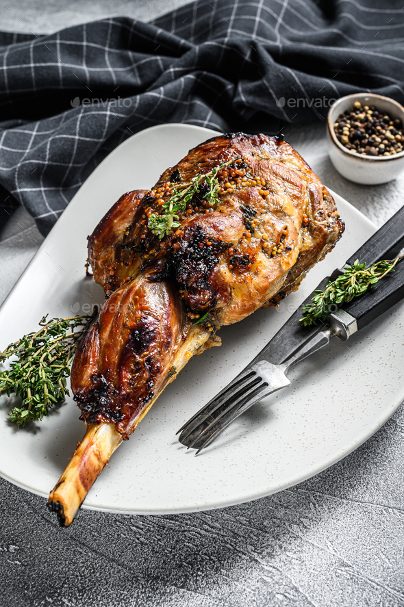 BBQ lamb leg with herbs. Gray background. Top view Stock Photo by ...