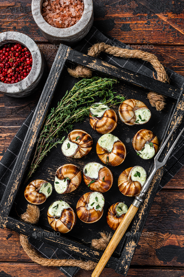 French gourmet - Escargot Snails with garlic butter in a wooden tray ...