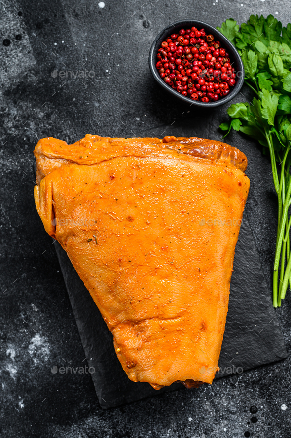 Raw pork leg with herbs and marinate on table. Black background. Top ...