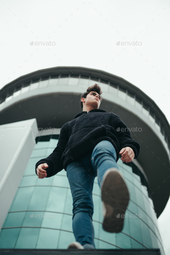 from below Young man stepping down Stock Photo by ADDICTIVE_STOCK ...
