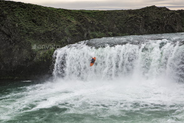 Canoe with person falling from waterfall Stock Photo by ADDICTIVE_STOCK