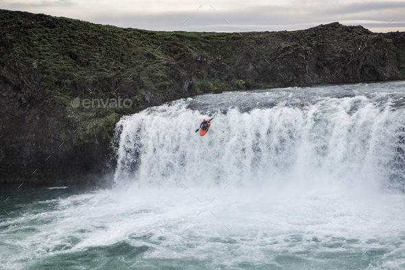 Canoe with person falling from waterfall Stock Photo by ADDICTIVE_STOCK