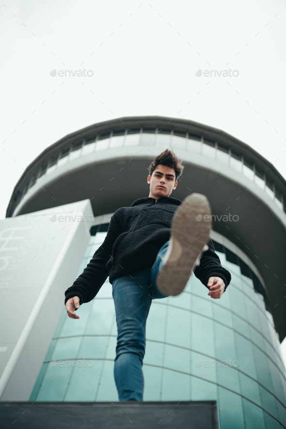 from below Young man stepping down Stock Photo by ADDICTIVE_STOCK ...