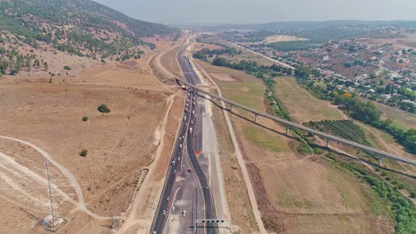 Aerial footage of large highway construction project with tunnels and ...