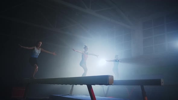 Training of Female Gymnasts Girls on Balance Beam Three Adolescents are ...