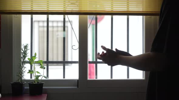 Unrecognizable man clapping from his window, claps for healthcare ...